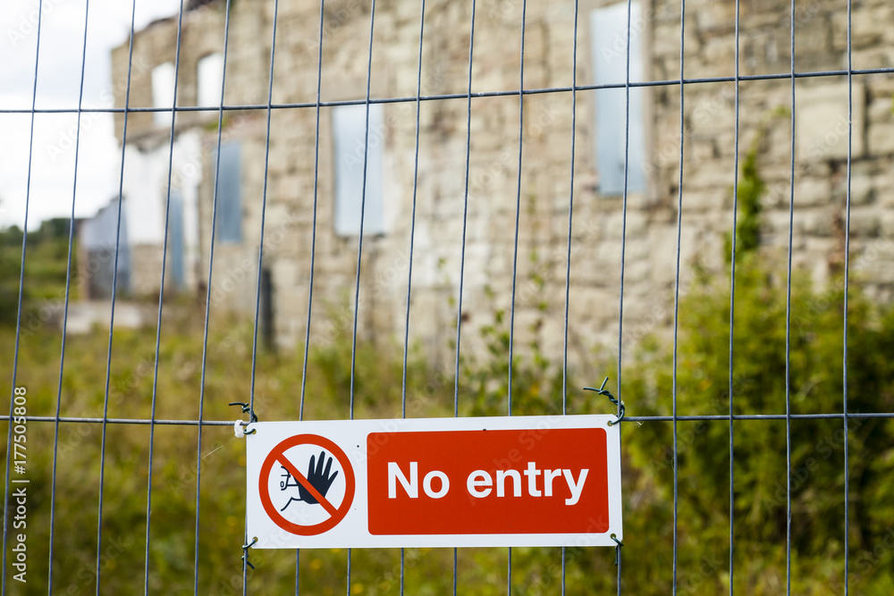 Red and white No Entry sign attached to a metal grid fence. Stock Photo ...