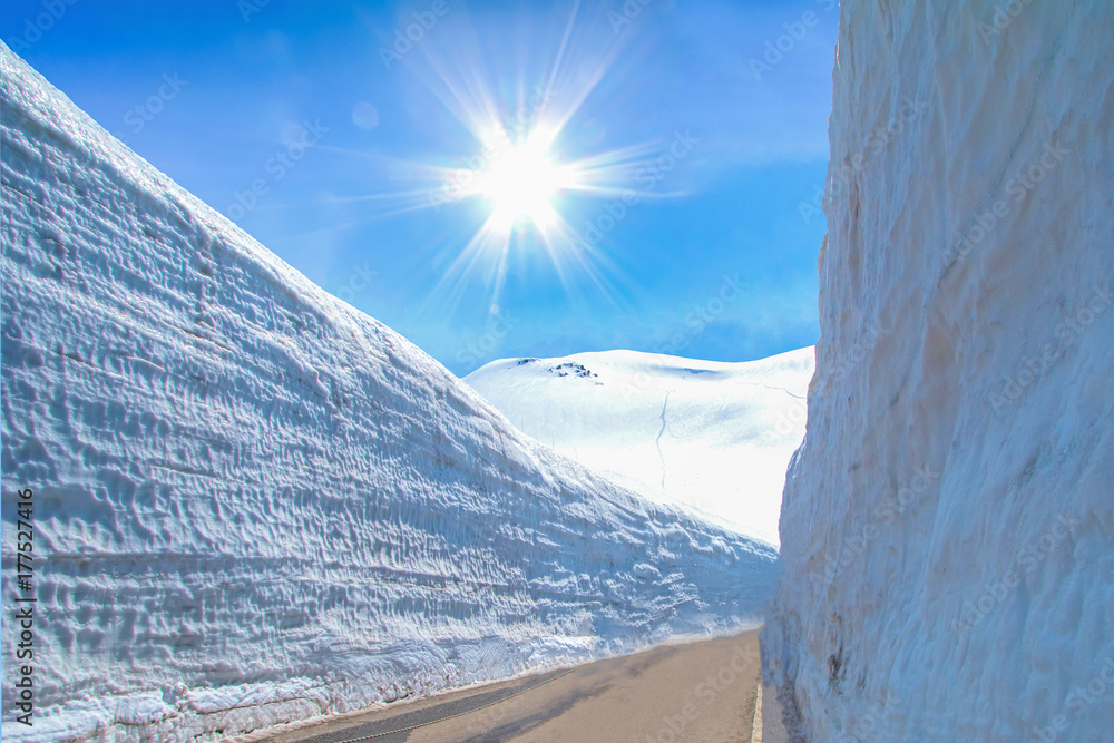 The snow mountains wall of Tateyama Kurobe alpine with blue sky ...