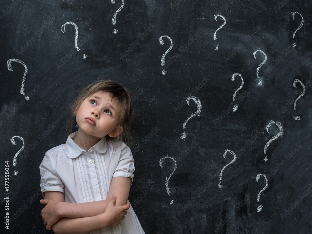 Little girl with question mark on blackboard. Concept for confusion ...