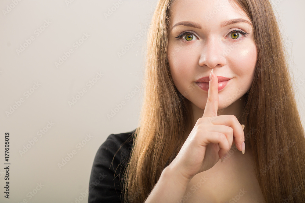 Cute girl doing silence gesture on studio background Stock Photo ...