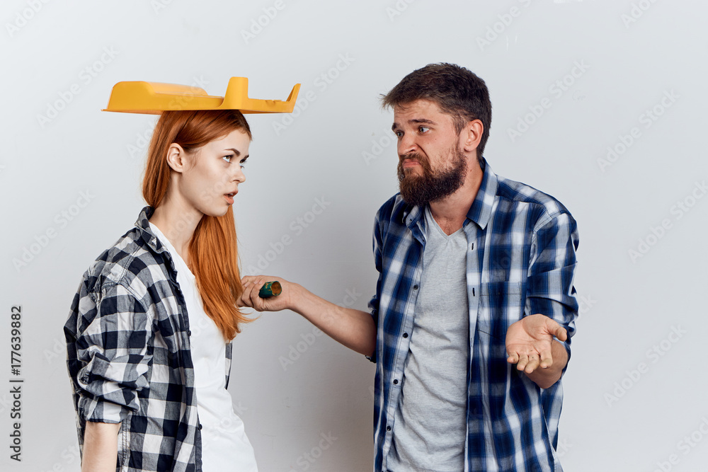on the head of a woman a plastic molar bath, a man with a beard on a ...