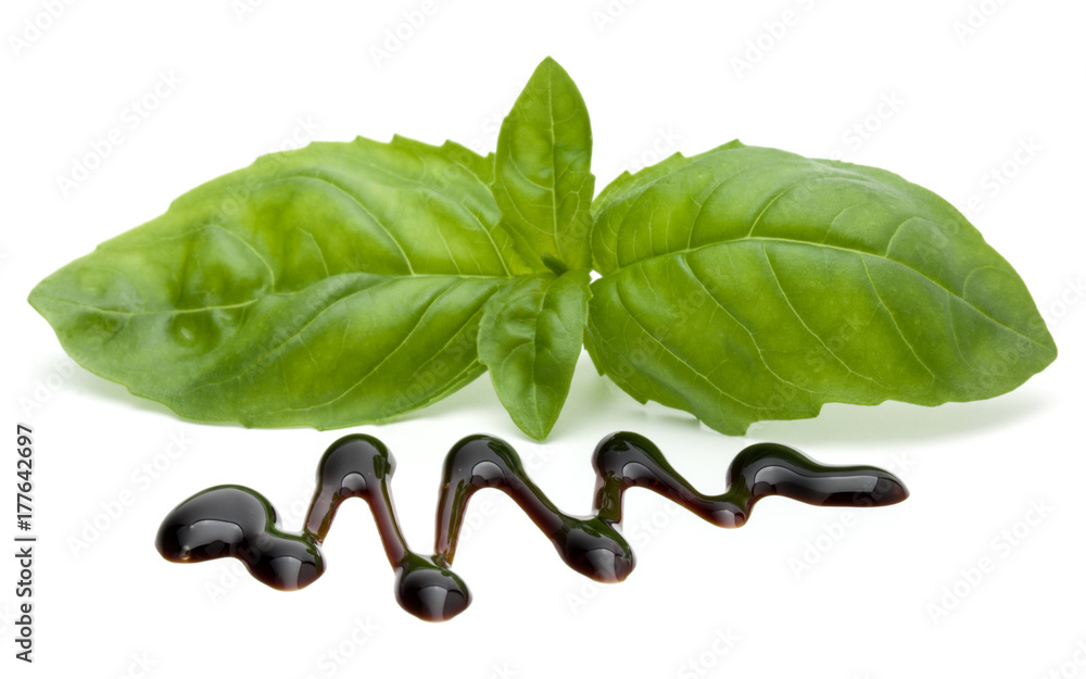 Balsamic vinegar cream and basil leaves isolated on white background ...