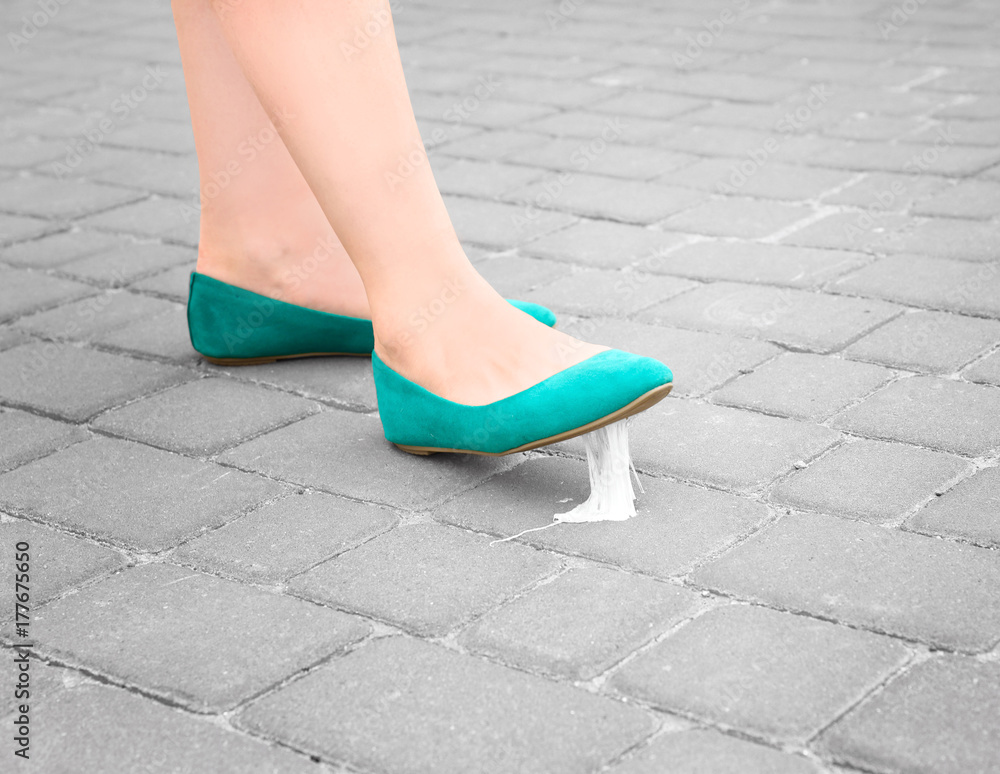Female foot stuck into chewing gum on street. Concept of stickiness ...