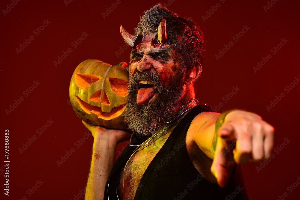 Halloween satan show tongue with bloody horns, beard, blood, wounds ...