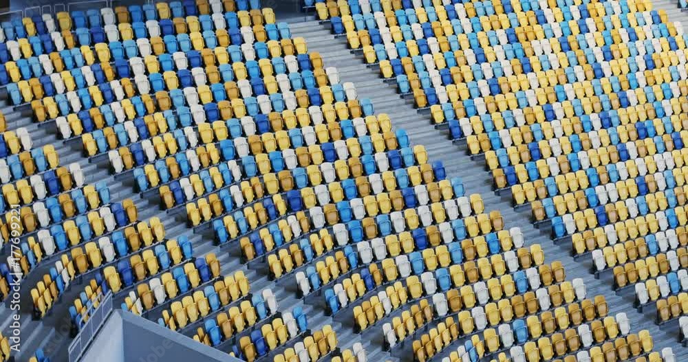 side view blue yellow white colorful empty stadium seats spectators ...