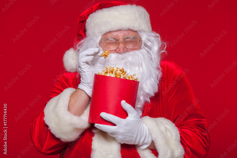 Traditional Santa Claus watching TV, eating popcorn. Christmas. Red ...