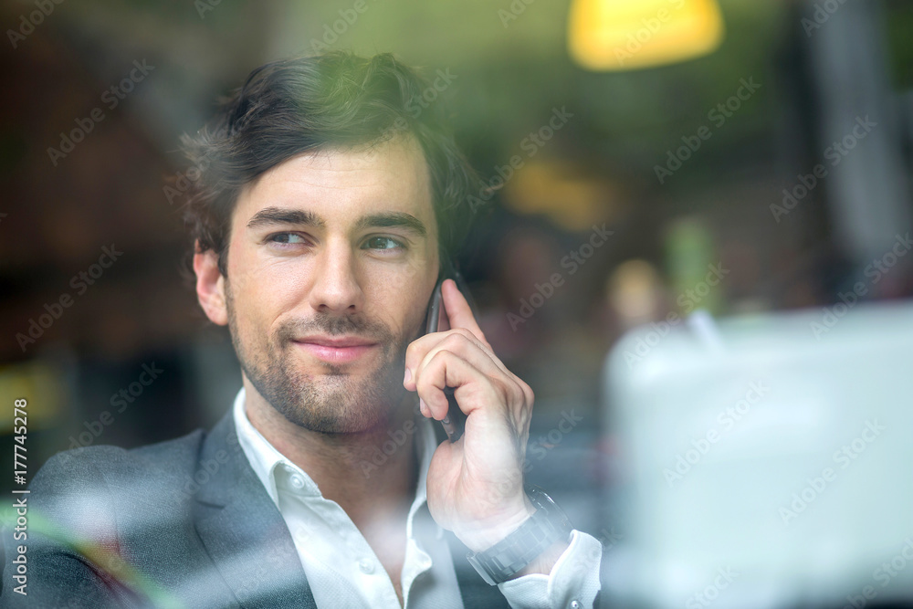 A handsome young man in the window Stock-Foto | Adobe Stock