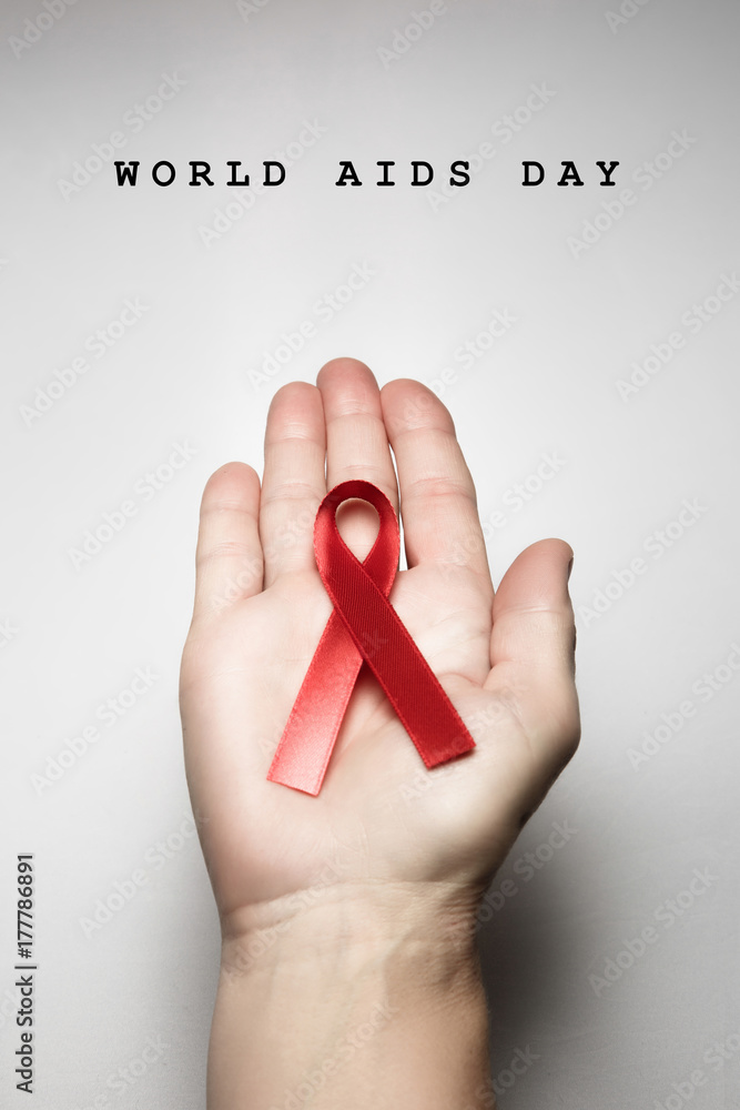 Red ribbon awareness on woman human hand aged white background: World ...