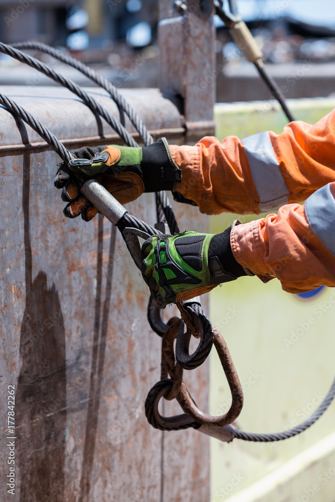 Able seaman is connecting sling. Crane loading operations on deck of ...