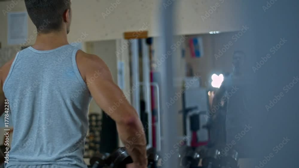 The man trains the biceps and arms muscle on the block device Stock ...