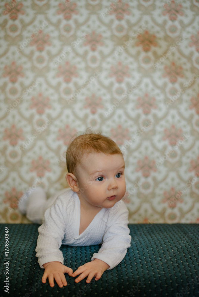Cute baby girl lying in front of the vintage wallpaper Stock Photo ...