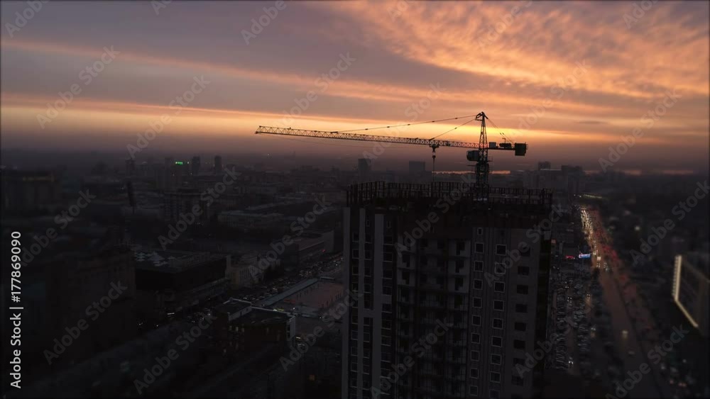 Aerial bird view of yellow tower building crane fly around construction ...