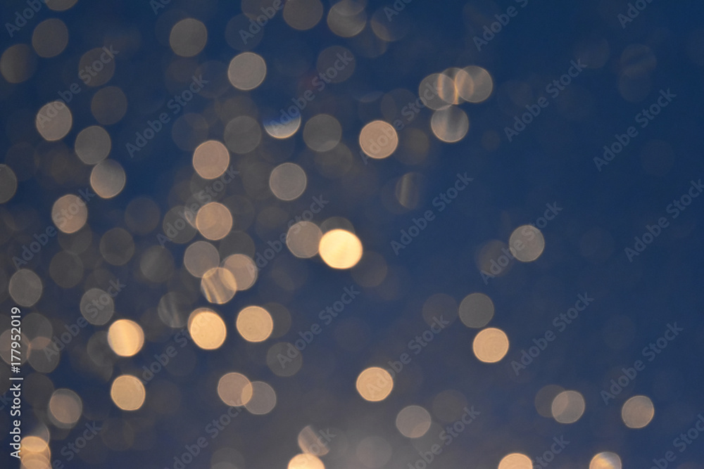 Glittering bokeh circular gold on blue background. Stock Photo | Adobe Stock