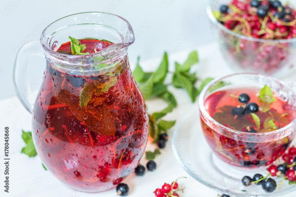 Fruit drink in transparent glass carafe and cup Stock Photo | Adobe Stock
