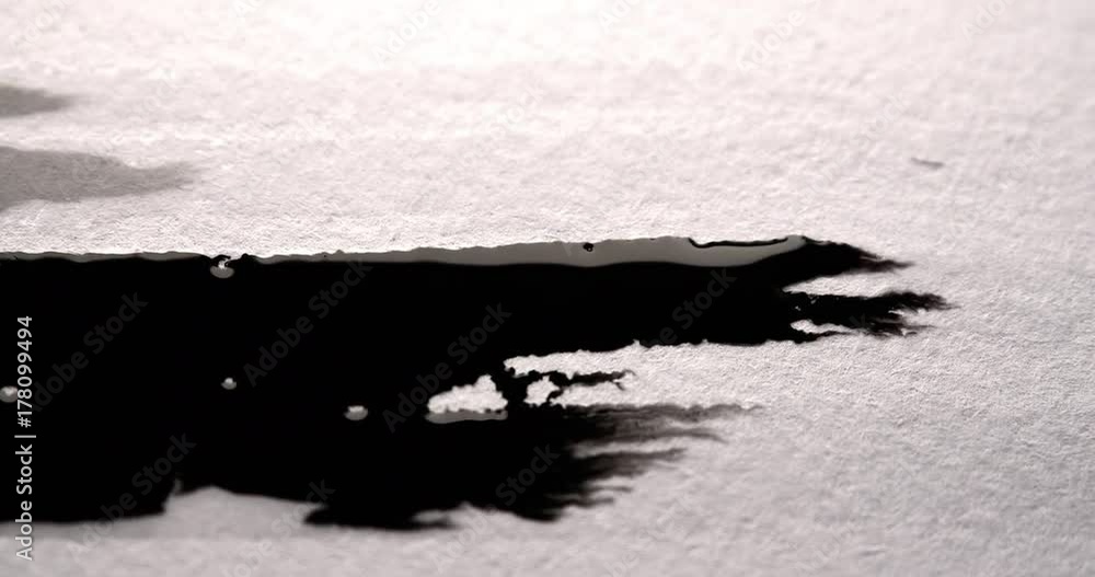 Black ink run and bleeding in white paper. Ideal ink texture to add to ...