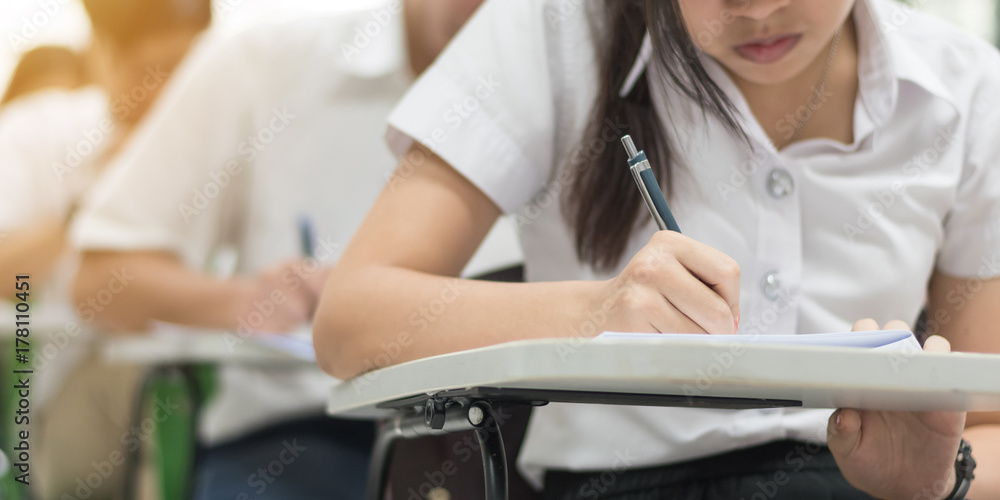 School exam, education concept with student's taking examination or ...