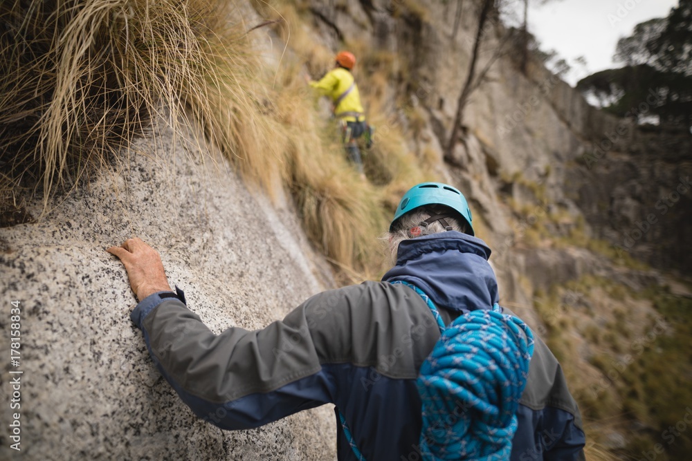 Man climbing a mountain Stock Photo | Adobe Stock