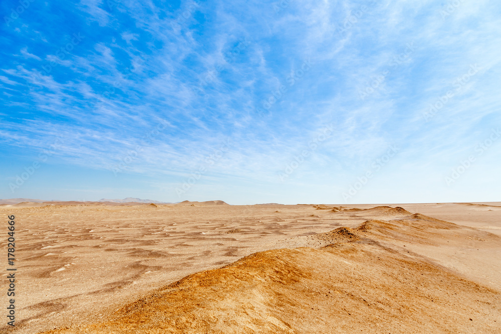Blue sky with clouds and yellow sands of Paracas desert national park ...