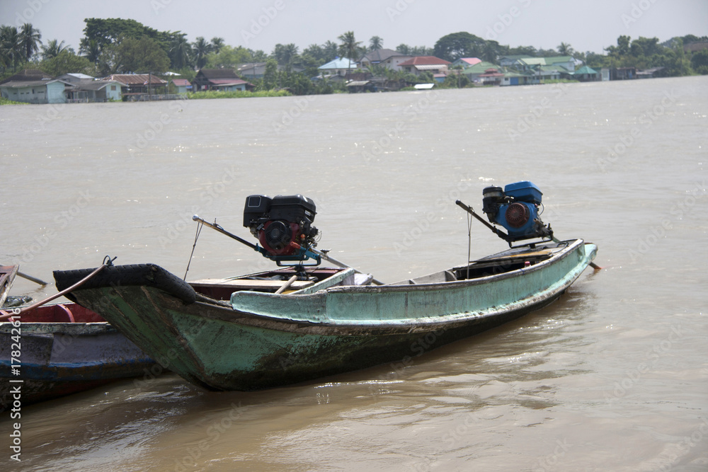 Two wooden boat machine landing on the water in the river. it is a ...