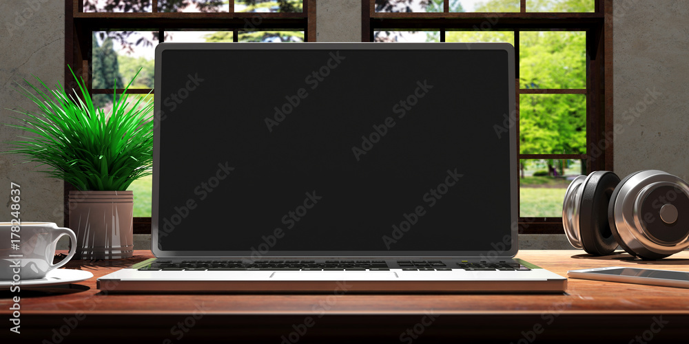 Laptop with black screen on wooden desk at home in front of a window ...