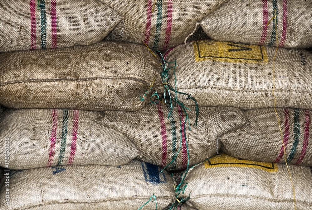 Stack of bags of coffee beans. Photos | Adobe Stock