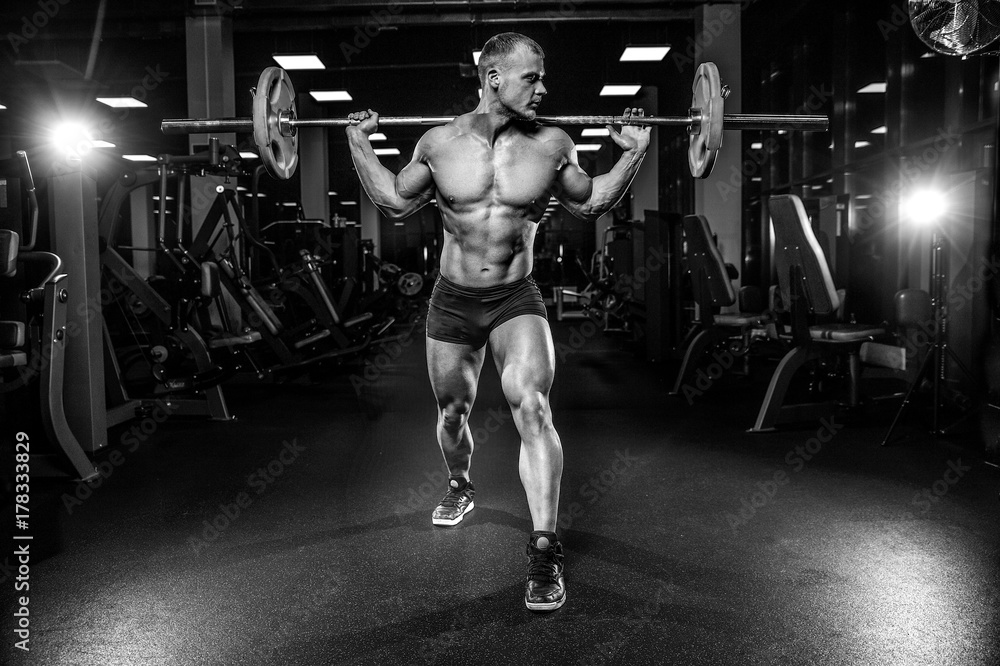 Handsome model young man training legs in gym Stock Photo | Adobe Stock