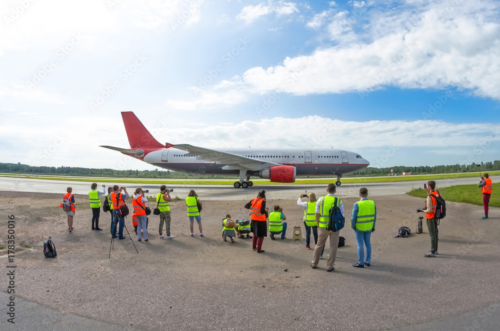 Airplane is ready for departure and take-off, a crowd of people sees ...