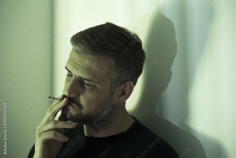 Nervous man smoking cigarette Stock Photo | Adobe Stock