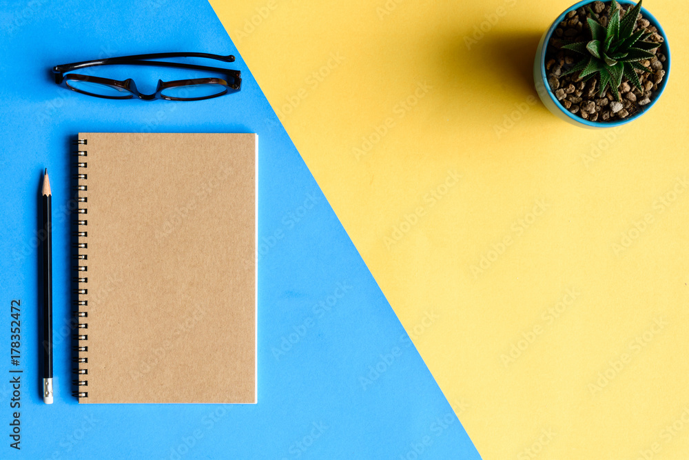 notebook and pencil on yellow desk Stock Photo | Adobe Stock