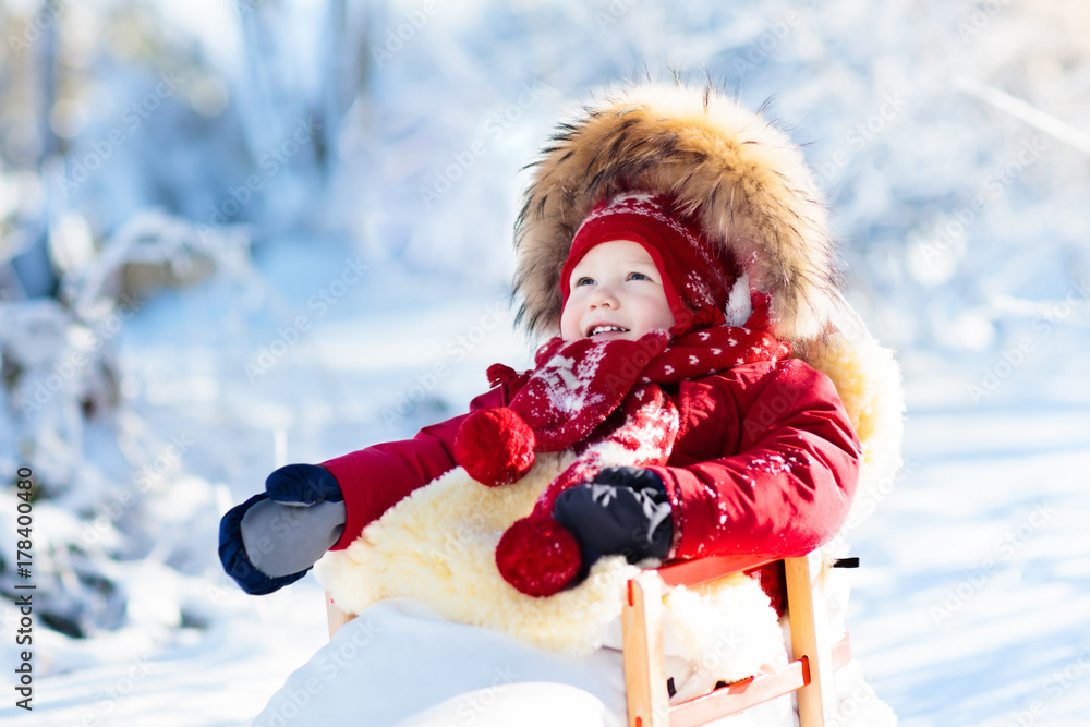 Sled and snow fun for kids. Baby sledding in winter park. Stock Photo ...