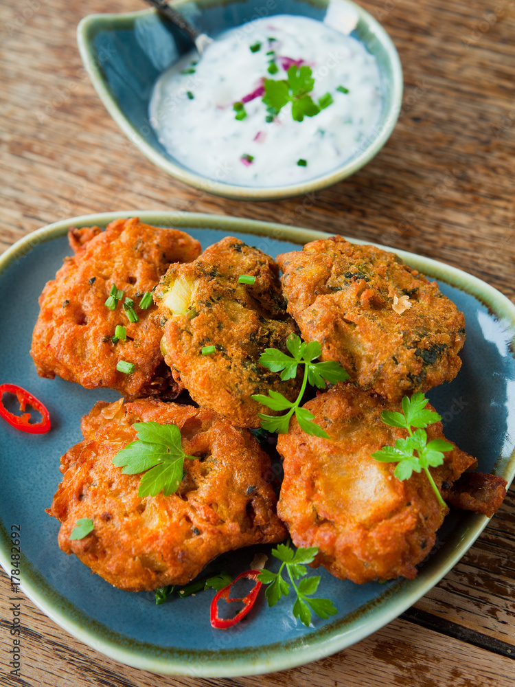 Indian vegetable pakora with fresh raita, chili and coriander leaves ...