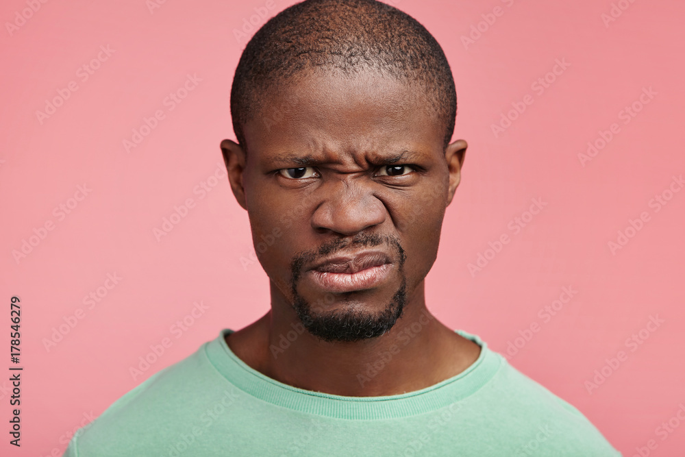 Displeased discontent African American male frowns face, dislikes ...