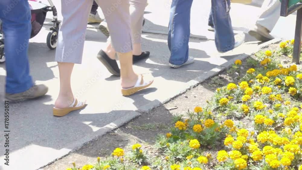 Feet crossing sidewalk. Summer sunny day. Low angle view of crowd foot ...