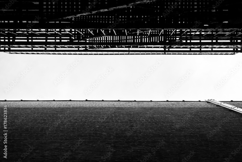 Urban alleyway view looking up. Street alley view of steel fire escape ...