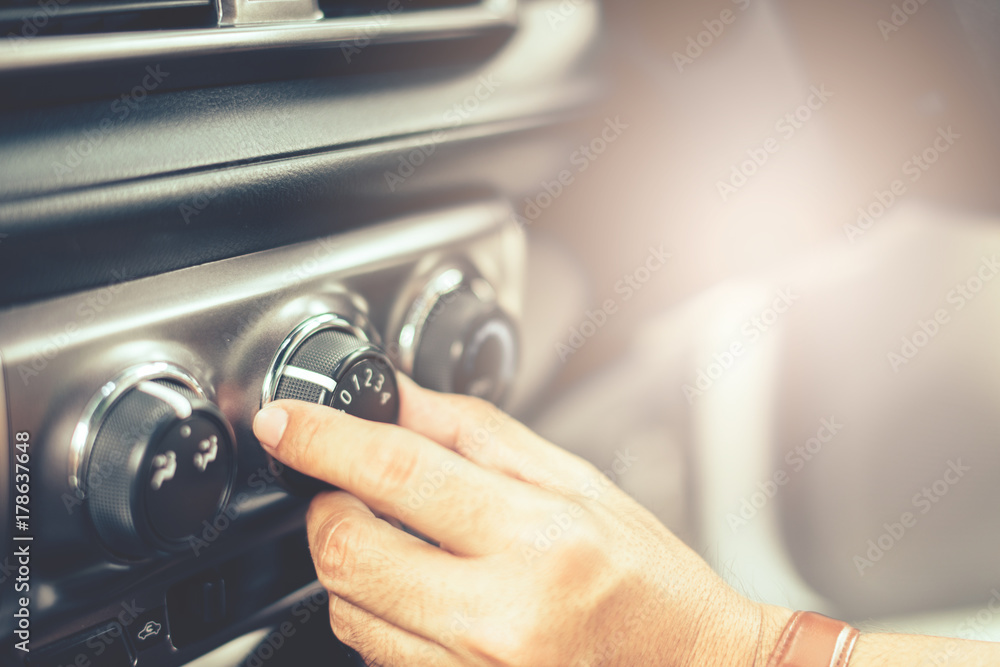 Hand of man turning on car air conditioning system,finger hitting car ...