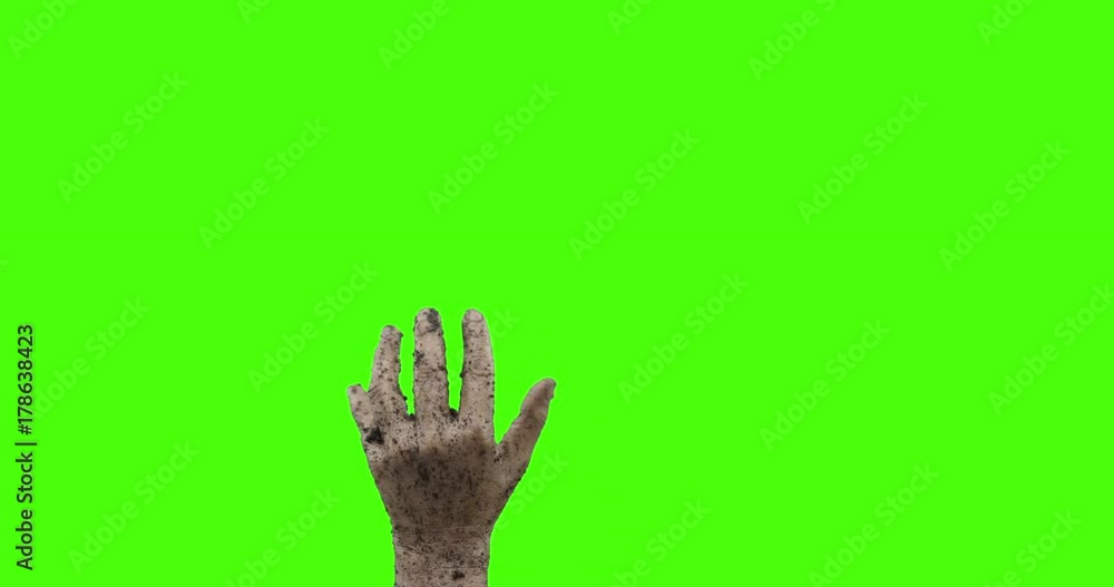 Undead - Hands of a zombie who is rising from the „dead“ and coming out ...