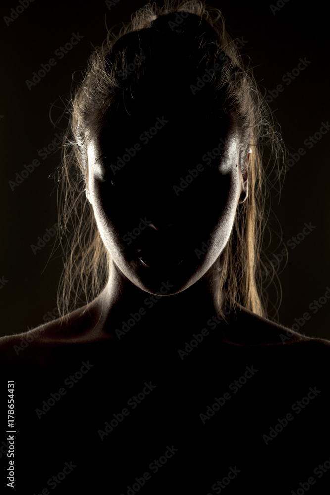 Misterious portrait of woman in shadow on dark background Stock Photo ...