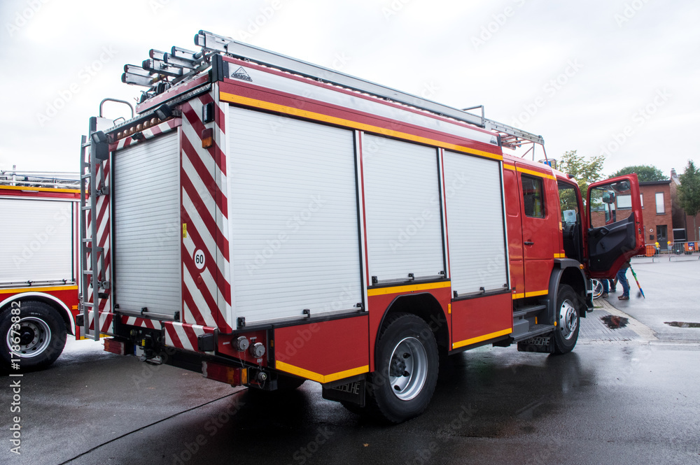 Red european fire truck, three-quarter back view, with gray hatches and ...