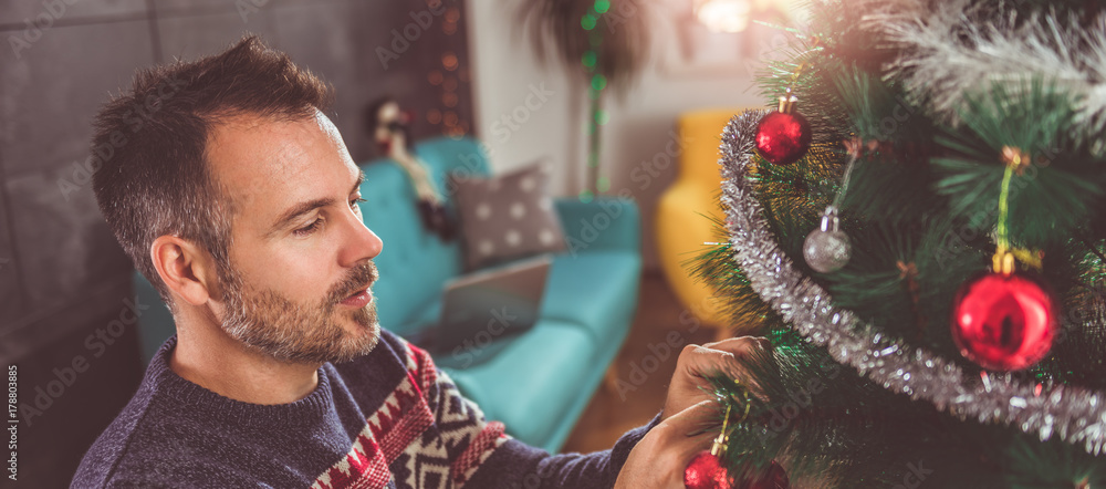Men decorating Christmas tree Stock Photo | Adobe Stock