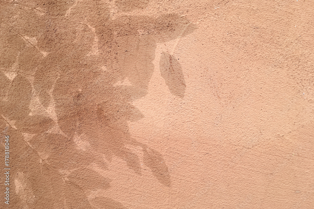 Closeup painted on exterior rough stucco wall Texture with shadow of ...