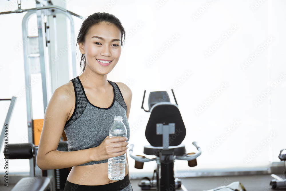Asian young tan woman drinking water after exercise, asian athlete ...
