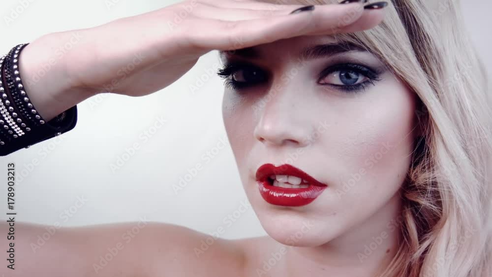 Beautiful young girl covers her eyes with palm her hand.Bright makeup ...