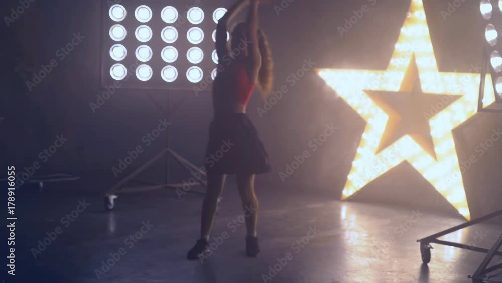 A young professional dancer performs a fast number on stage in the ...