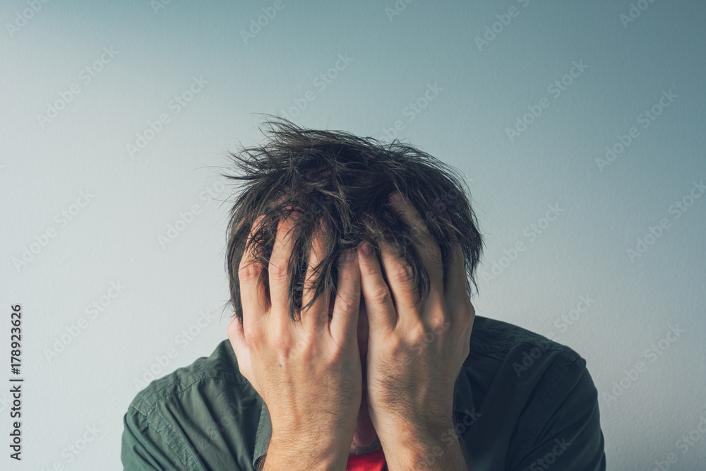 Disappointed man crying with head in hands Stock Photo | Adobe Stock