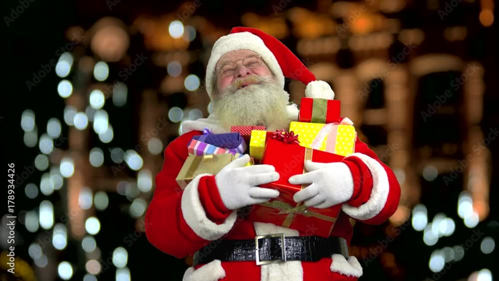 Santa laughing and holding presents. Happy Santa Claus. Gifts and joy ...