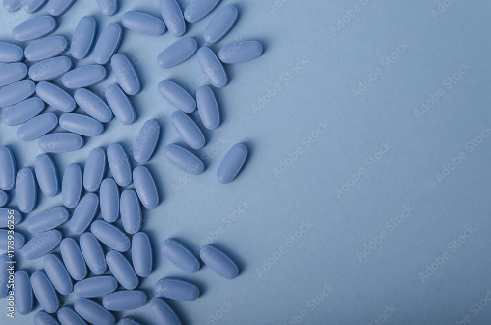 random composition of blue tablets over a light blue background, empty ...