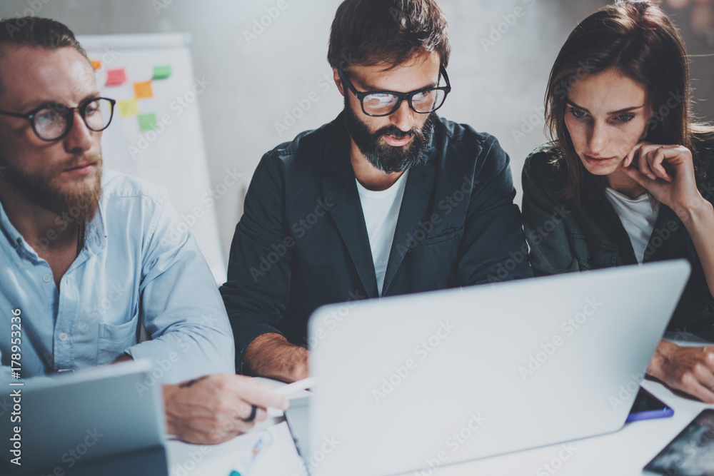 Project team working together in meeting room at night office ...