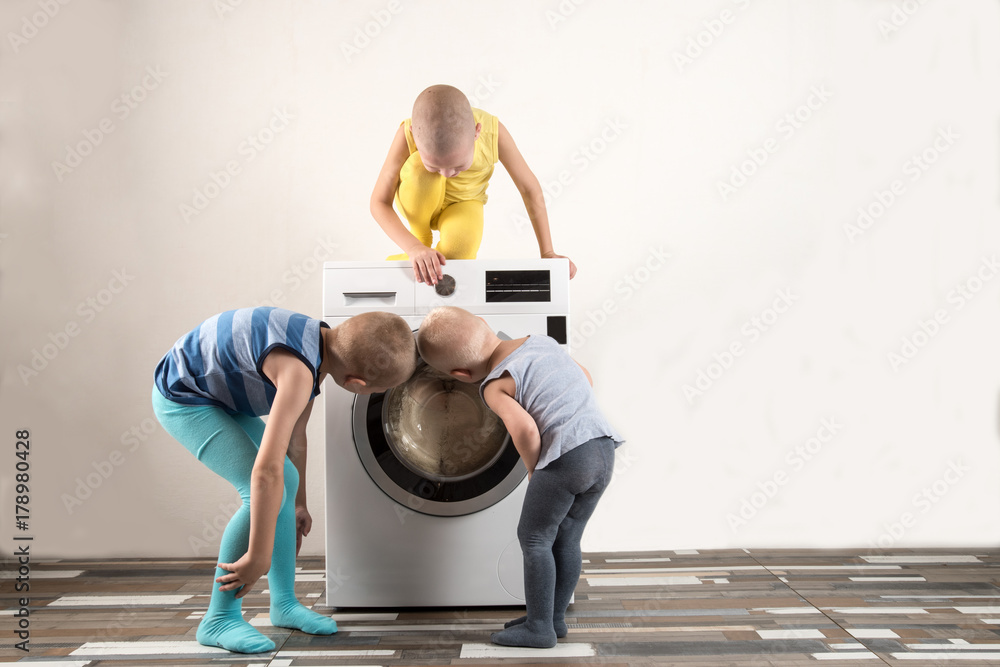 Parents bought a new washing machine. The children try to turn it on ...