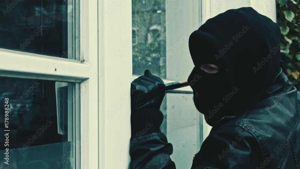 intruder or burglar with crowbar break door to enter the house Stock ...