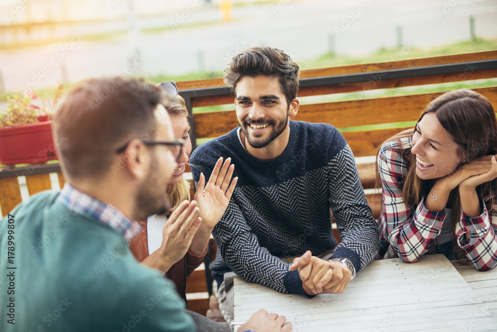 Group of four friends having fun a coffee together. Two women and two ...